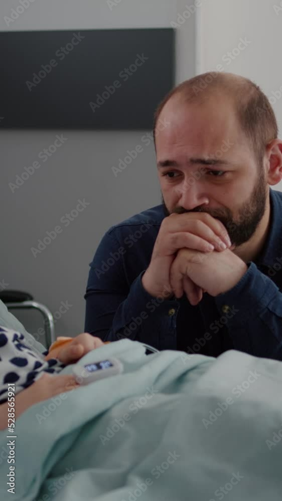 vertical video: Sick child daughter wearing oxygen nasal tube and ...