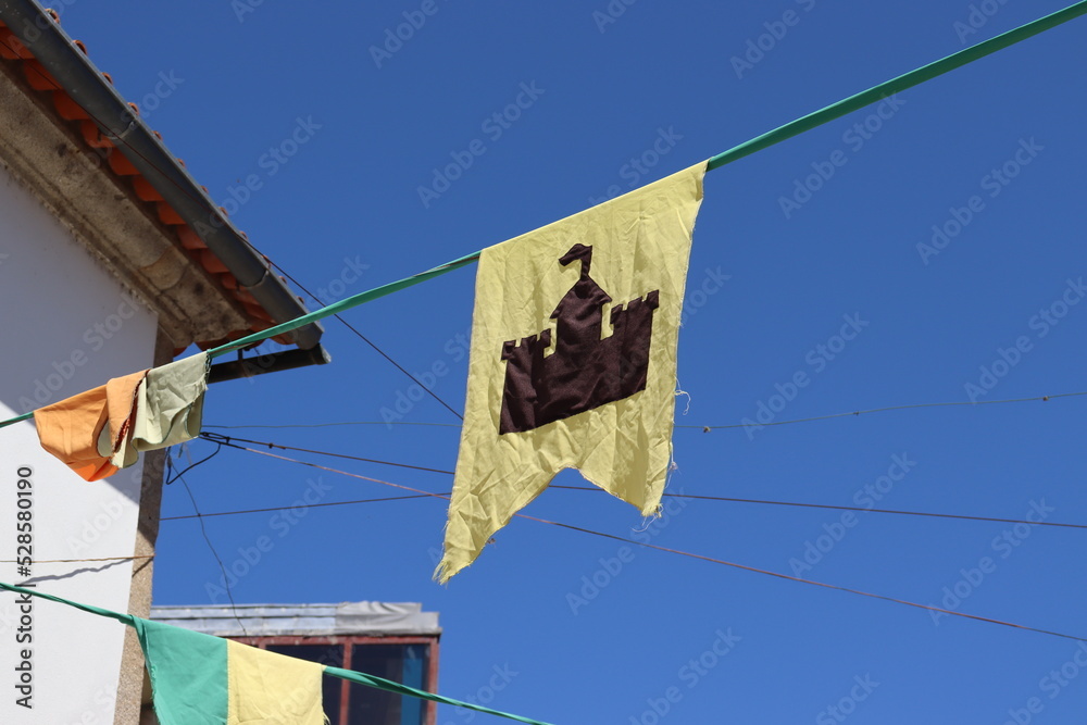 Detail of a yellow banner with the drawing of a medieval castle ...