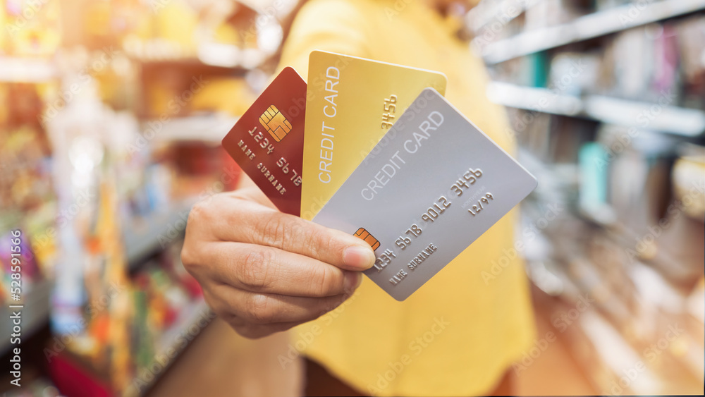 Credit card shopping in supermarket hand holding credit card payment ...