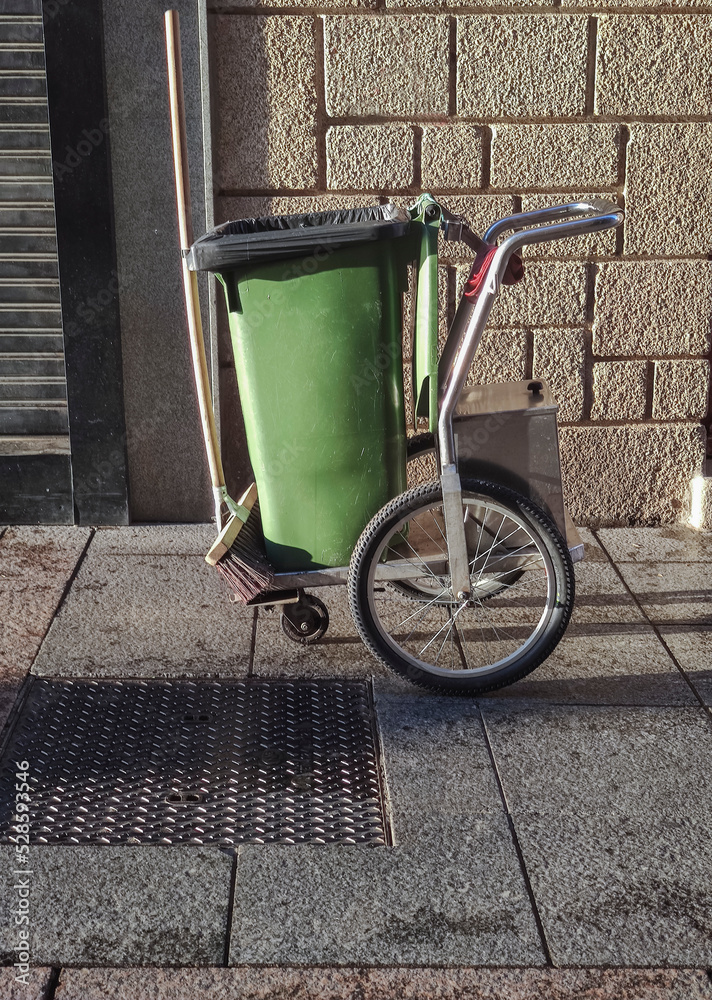 Street sweeper cart with green dumpster and sweep Stock Photo | Adobe Stock