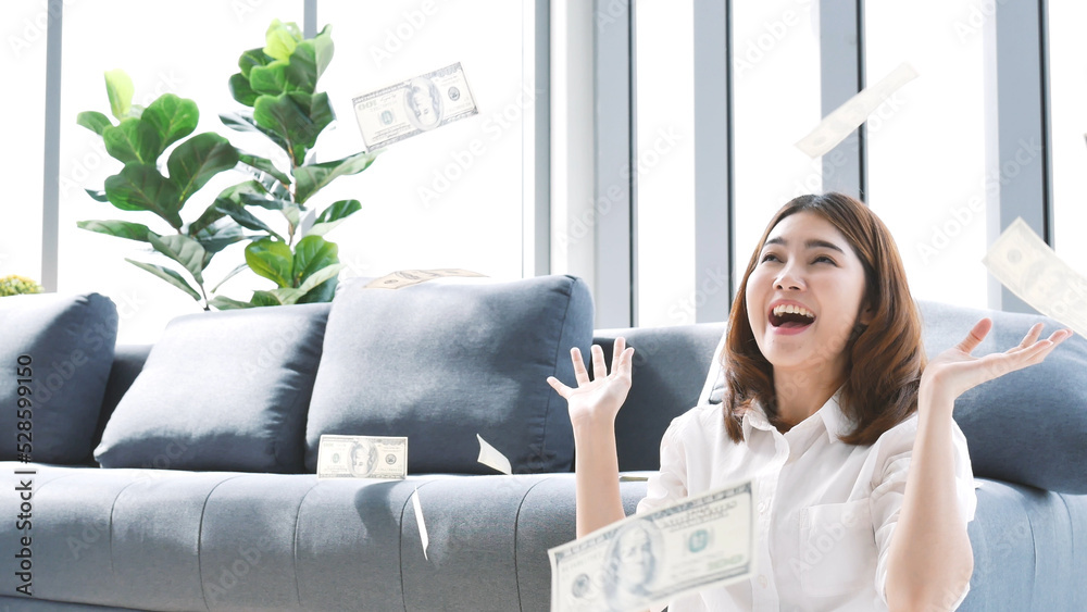 Happy young asian woman holding dollar money and throw in the air ...