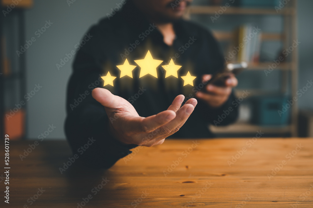 hand of customer or client holding the stars to complete five stars ...