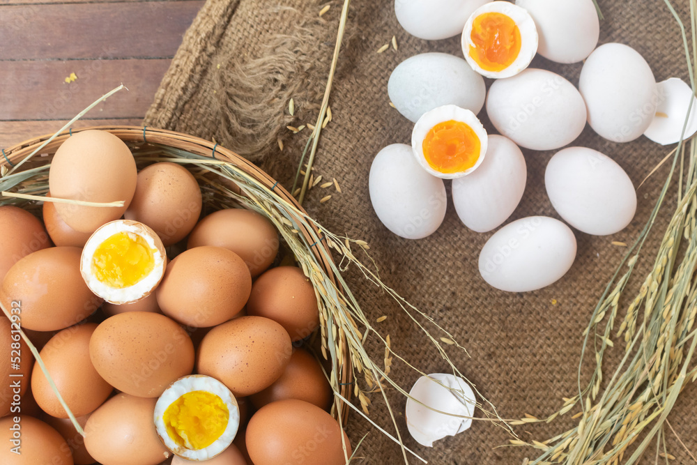 Hard-boiled chicken egg and its cross-section and soft-boiled duck egg and its cross-section on ...