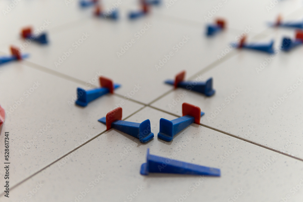 Installing ceramic floor tile in new construction work by tile glue for ...