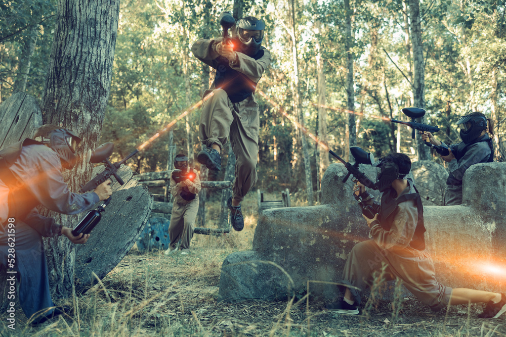 Teams facing on battlefield in outdoor paintball arena during the match ...