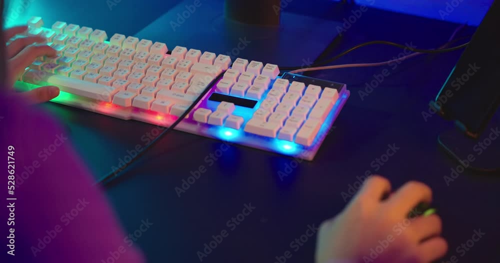 Vidéo Stock Close up gamer hands actively pushing buttons with colorful ...