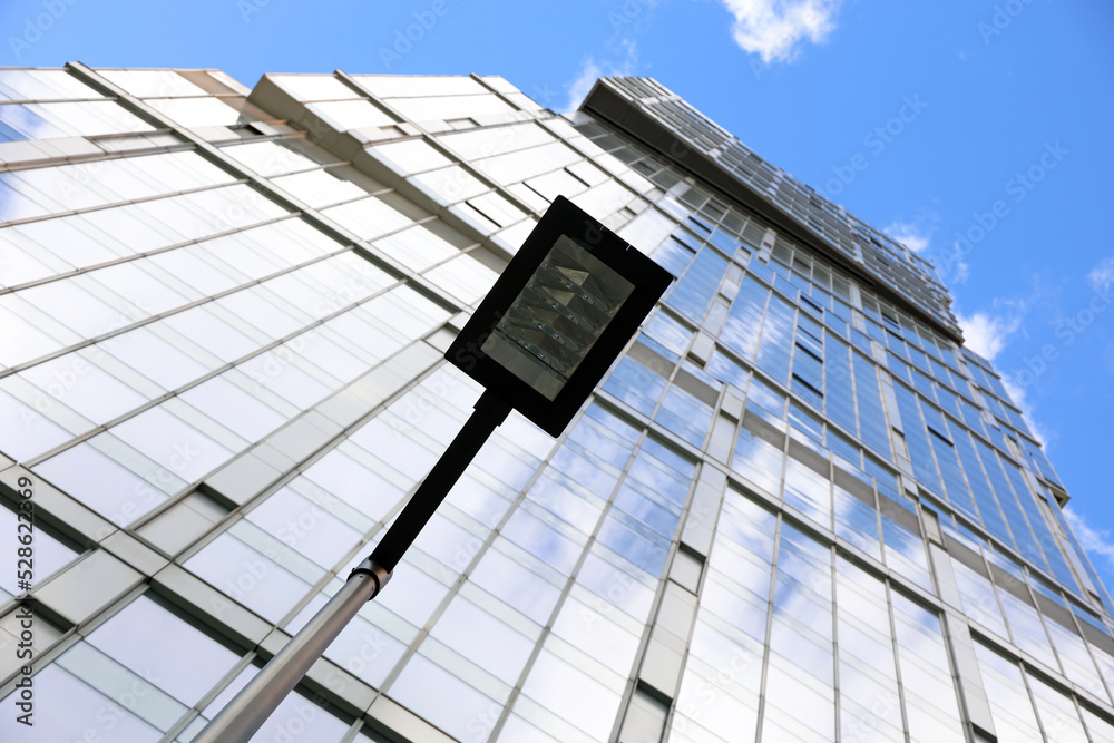 Led light on skyscraper background. Modern street lamp post in city ...