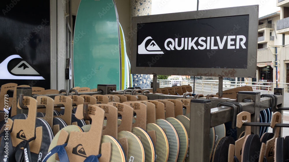 quiksilver chain surf wear clothes logo sign and brand text on shoes ...