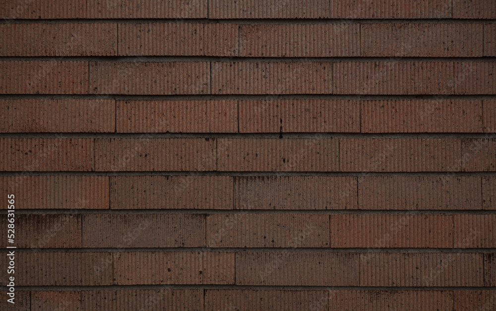 Dark brown brick tile wall background. Vertically striped patterned ...