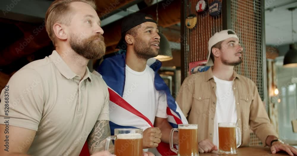 Fans watching football in a bar with friends. Loyal football fans ...