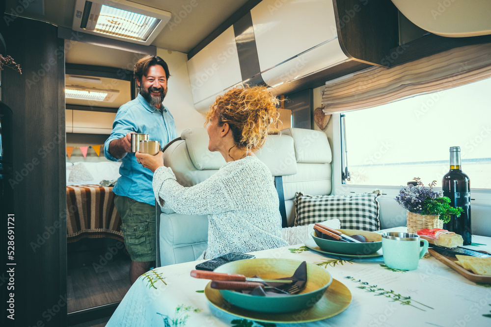 Couple living off grid inside a modern luxury camper van and enjoy ...