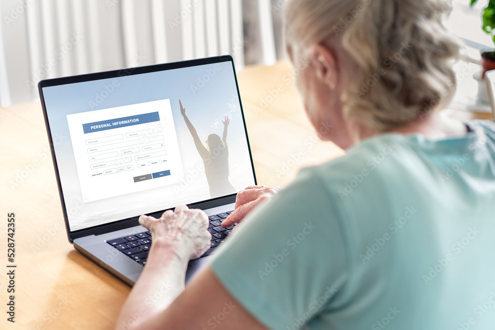 Old woman and elder senior using laptop. Online form to register data ...