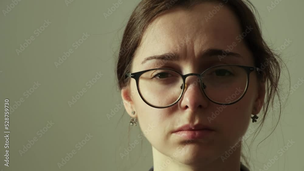 Portrait of a young 30 year old woman in a depressed state. Sad face close up. Untidy appearance ...