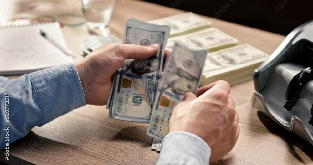 Close up of person hands holding and counting many dollars at desk at ...