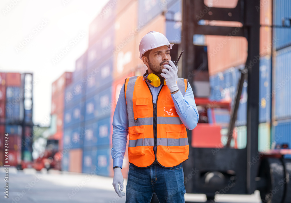 Supervisor dock cargo checking and control loading Containers box at ...