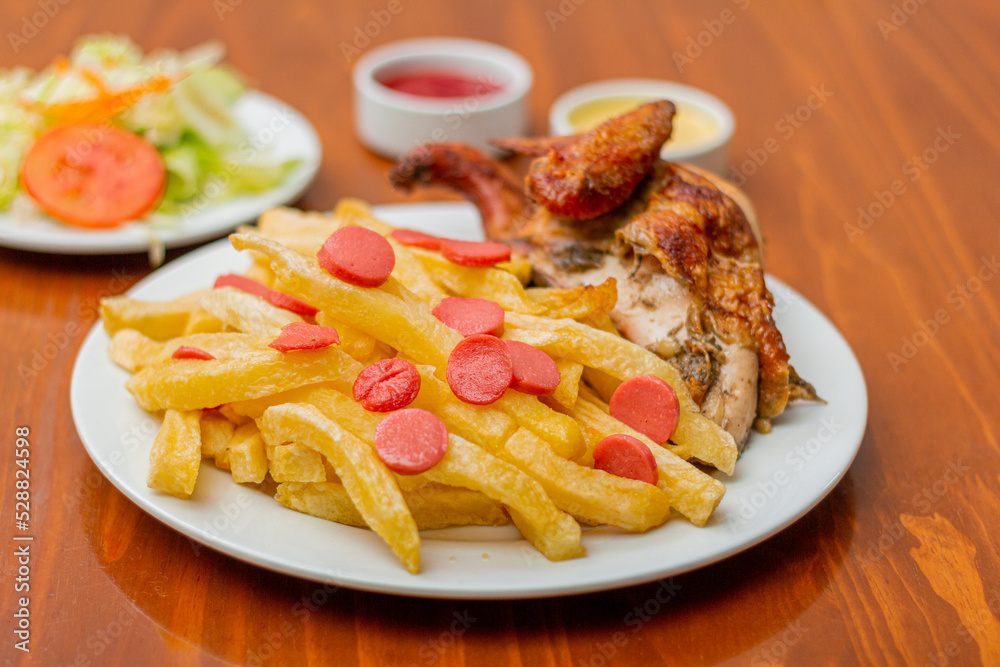 Peruvian dish called "salchipollo", grilled chicken, french fries and ...