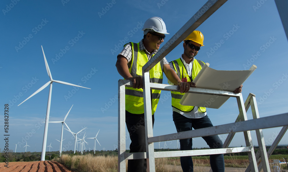 wind power station. Service engineer on wind turbine farm. Couple ...