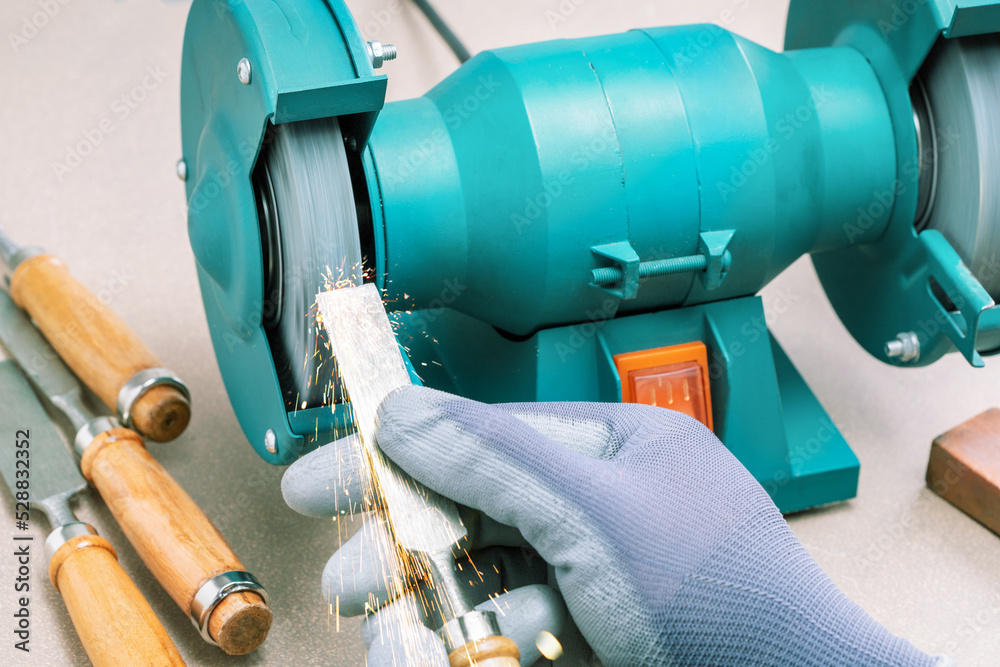 Carpenter sharpening a chisel in a workshop. Sharpening Work Tool On ...