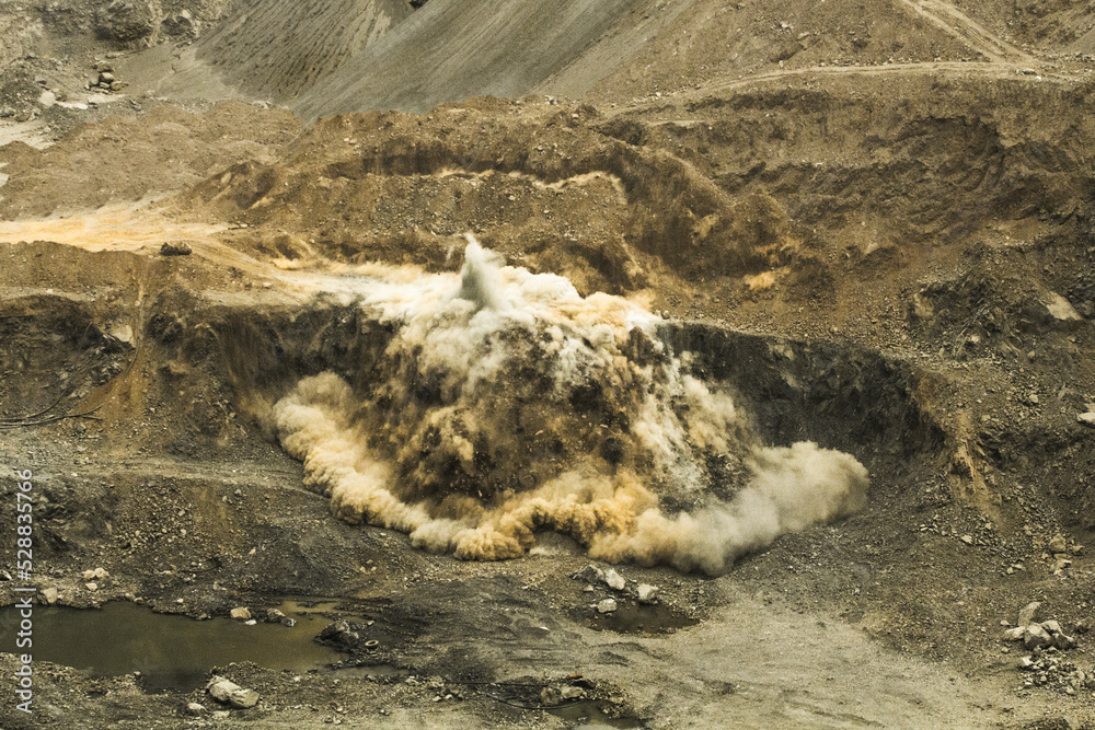 Blasting TNT explosion bomb rock in the open pit miner site Stock Photo ...