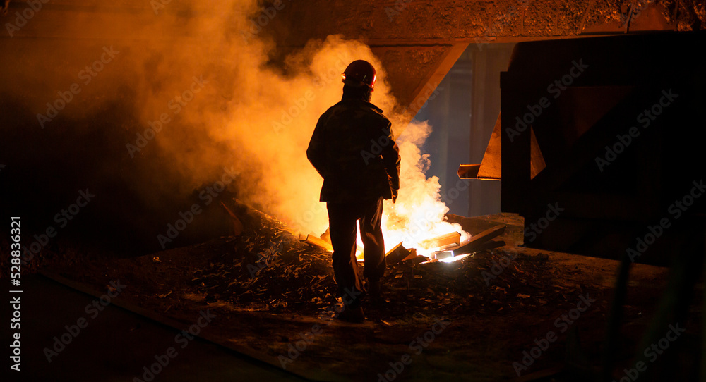 Iron smelting Hard work in the foundry, workers controlling iron ...