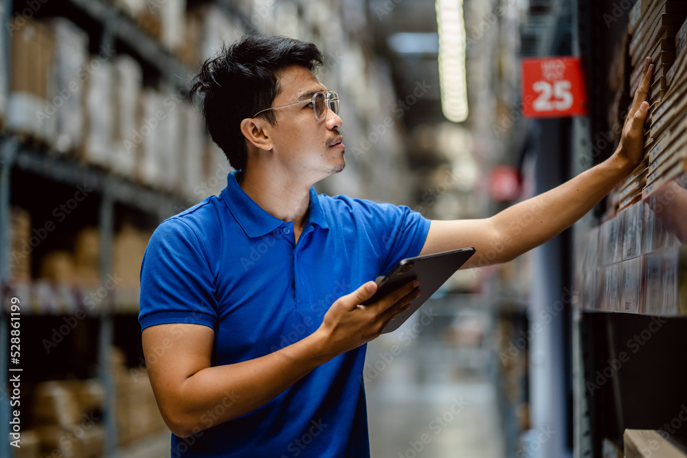 Warehouse Worker using digital tablets to check the stock inventory on ...