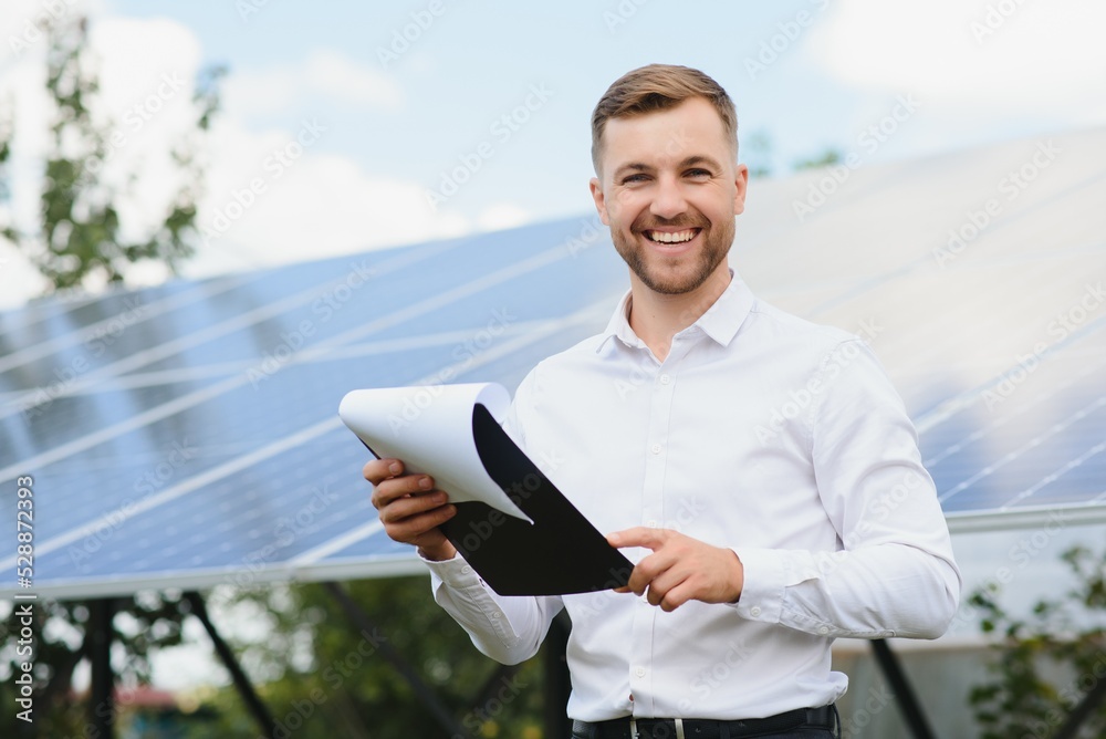 Engineer at solar power station with solar panel. Practical lessons on ...