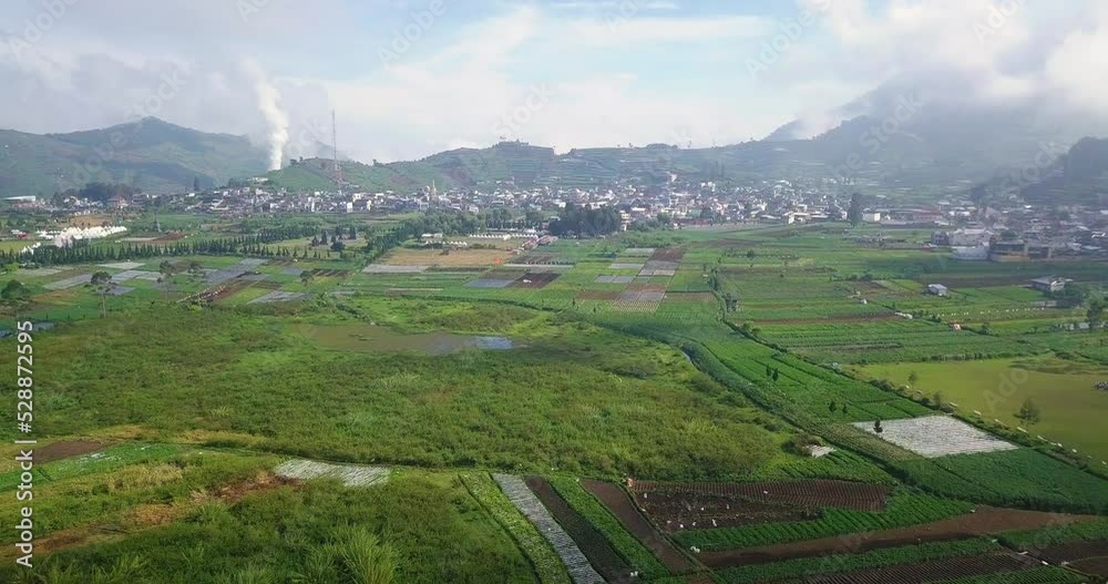 Sliding Drone shot of rural landscape of Dieng Plateau with view of ...