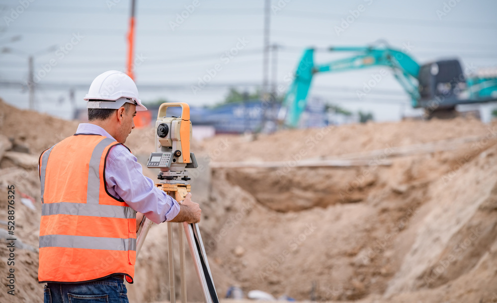 Surveyor engineer wearing safety uniform ,helmet and radio ...