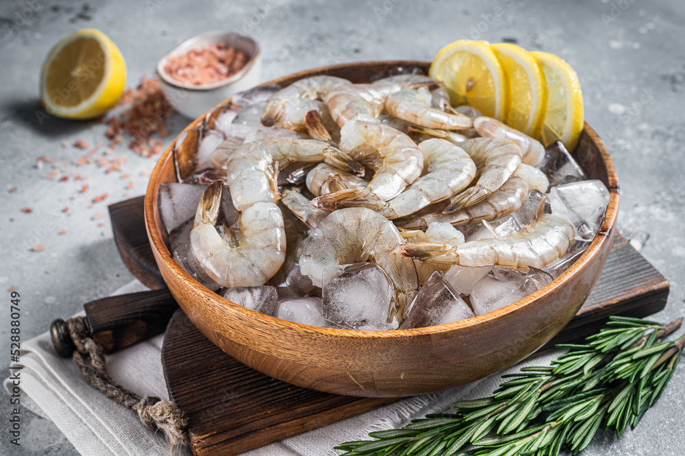Uncooked Raw peeled tiger white shrimp prawn. Gray background. Top view ...