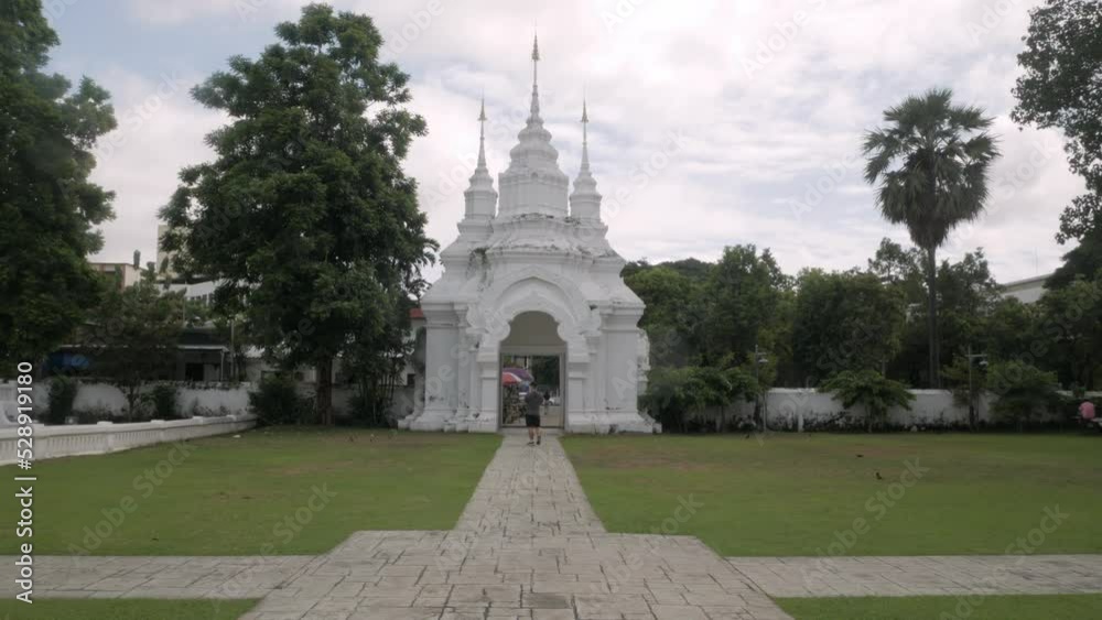 tourist asian man while taking photo near the ancient main gate of Wat ...