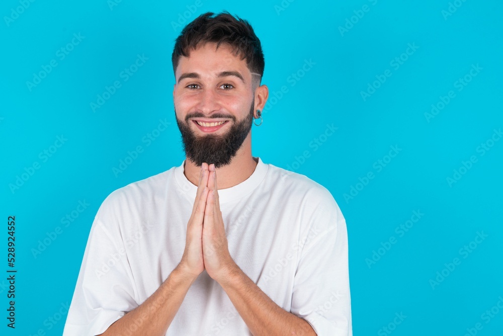 Bearded Caucasian Man Wearing White T Shirt Over Blue Background Keeps