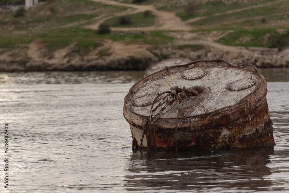 Raid barrel in the bay. A large metal barrel for mooring the ship ...