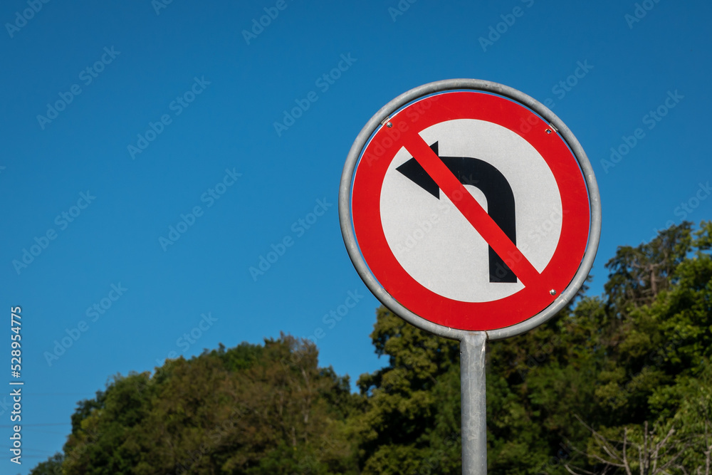 No left turn sign against blue sky. Traffic signs. Prohibited from ...