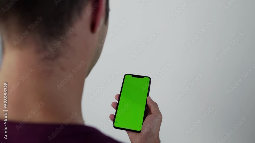 Camera from behind zoom out filming close up male man holding mobile ...
