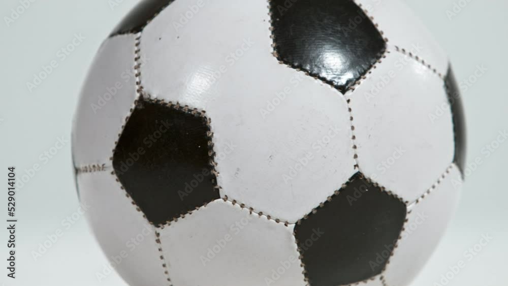 Super slow motion of rotating soccer ball on white background. Filmed ...
