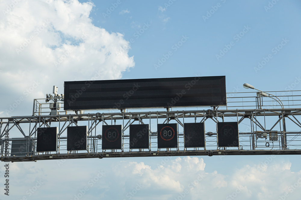 Information board with speed limit signs above expressway lanes. Moscow ...