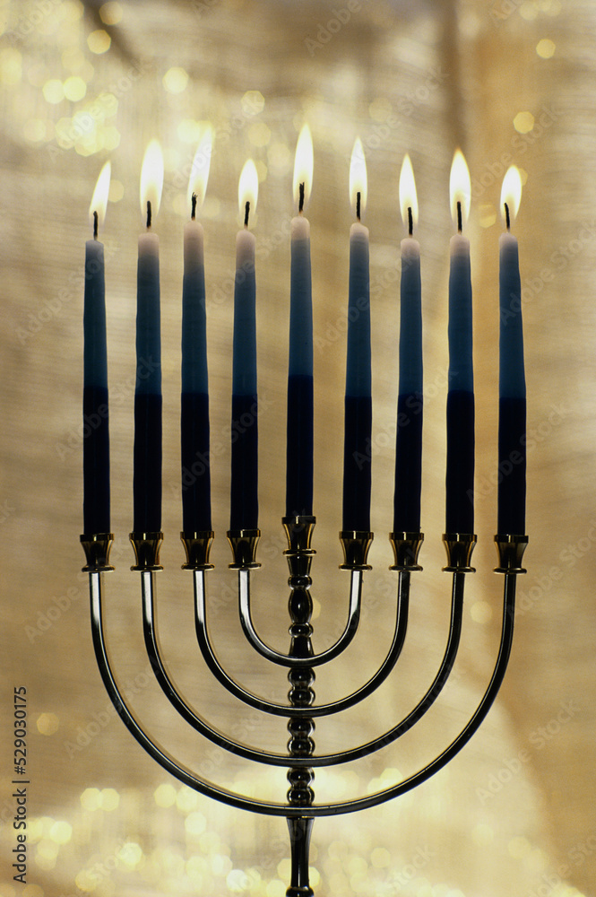 Lit candles on a menorah Stock Photo | Adobe Stock
