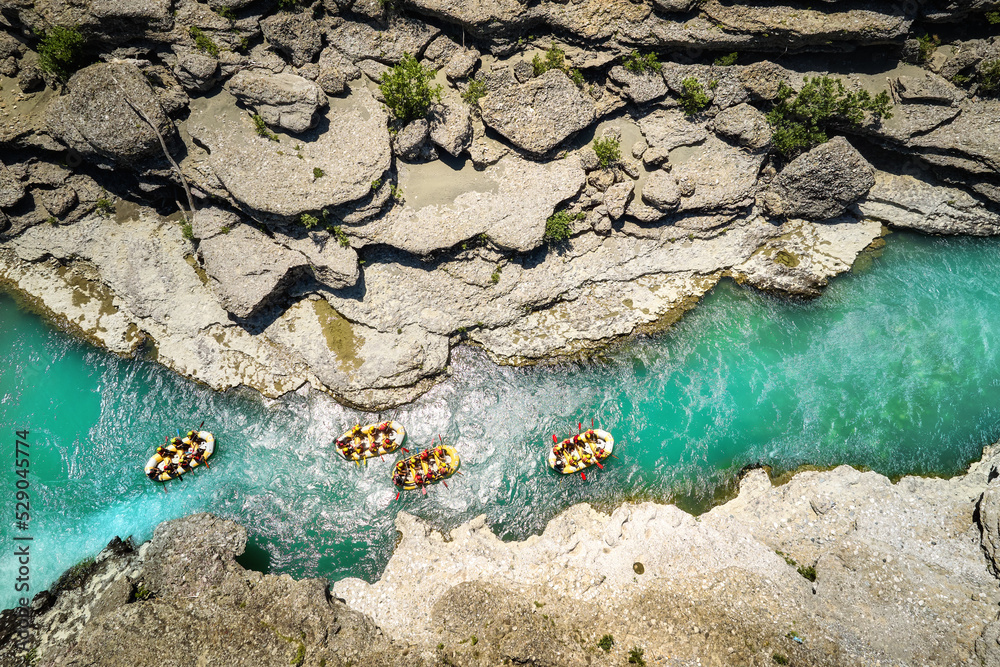 White water rafting. Adventure and sport. A group of four yellow rafts ...