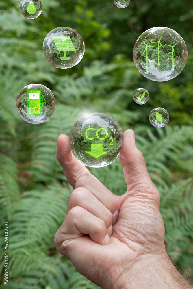 hand holding bubbles with icons of sustainable energy (solar energy ...