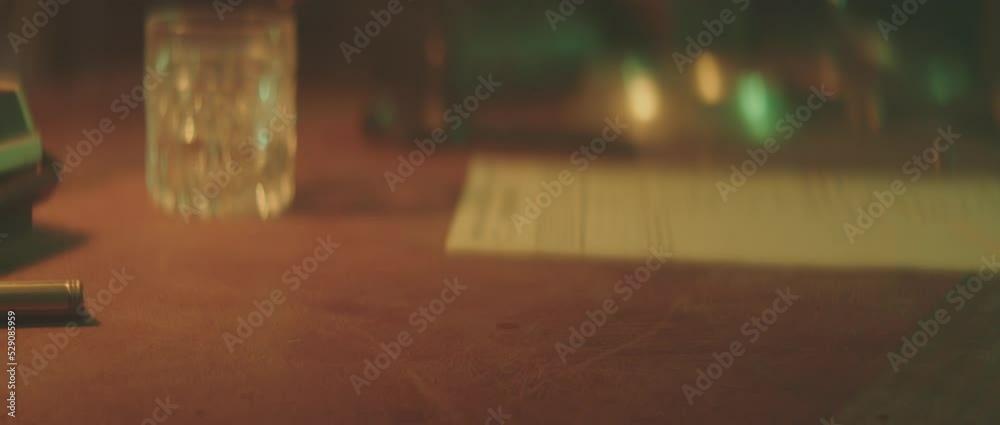 Revolver laying on table, male hand taking gun from board. Retro style ...
