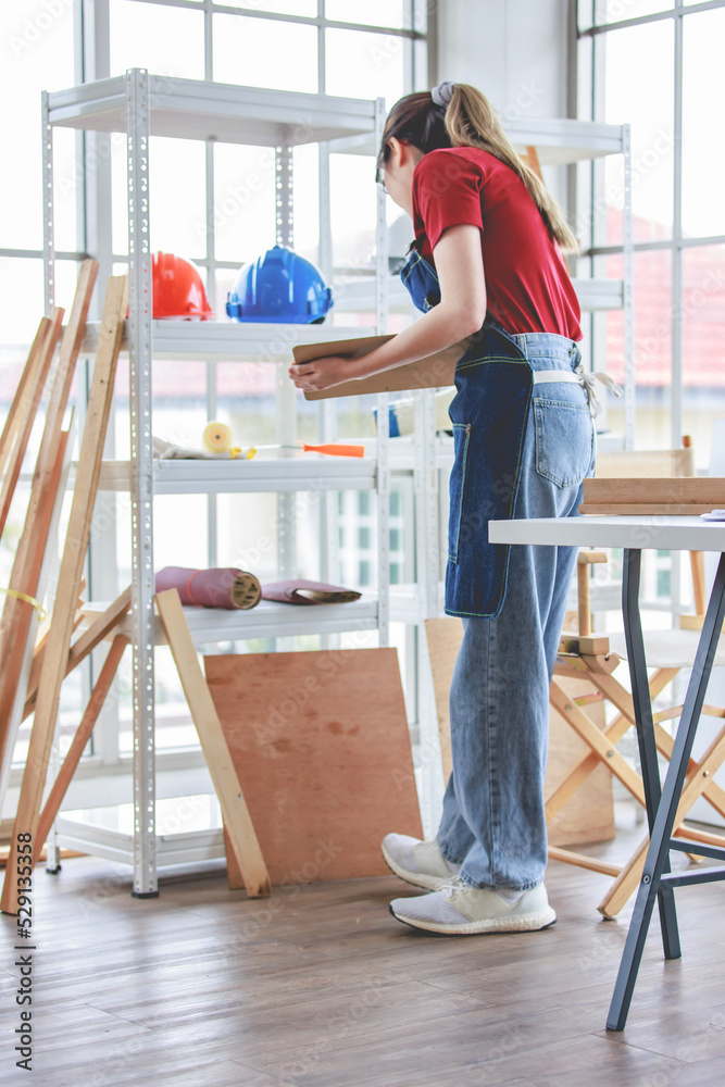 Asian professional female labor worker wears safety goggles and apron ...