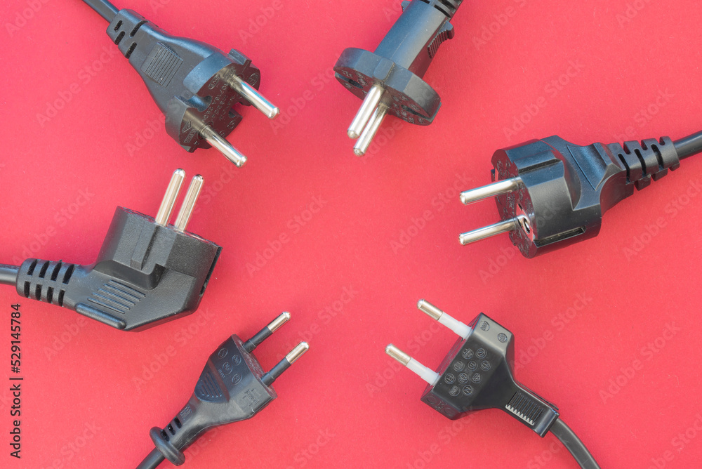 Six black power plugs arranged in a circle on a red background to ...