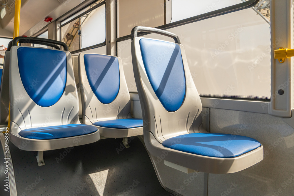 New comfortable seats inside a modern public bus. Seats on the bus for ...