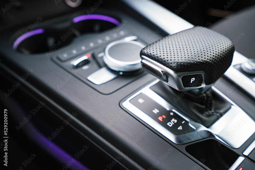 gear shifter knob inside a luxury car with purple neon lights. car ...