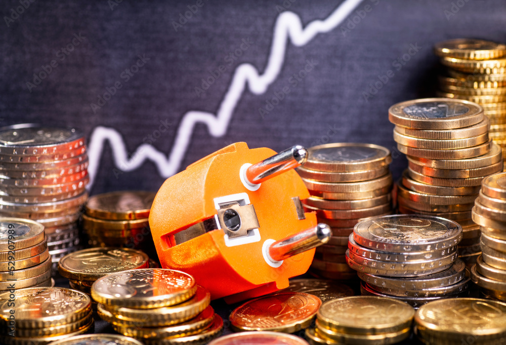 Rising electricity costs, plugs with stacks of money and graph with ...