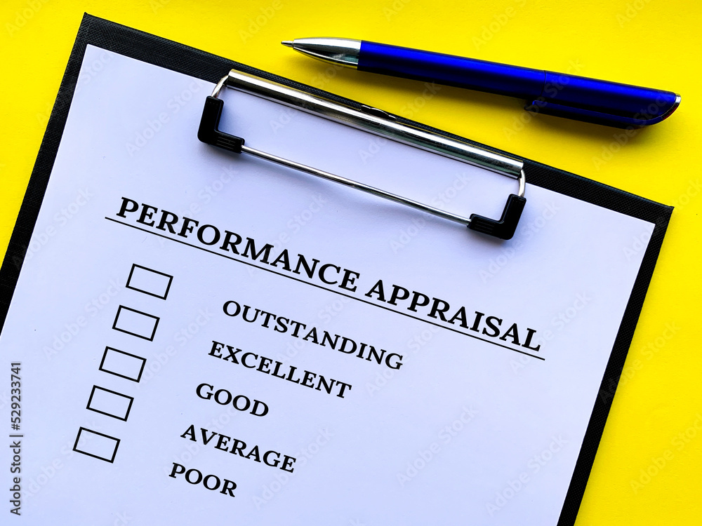 Top view of performance Appraisal checklist on clip board with yellow ...