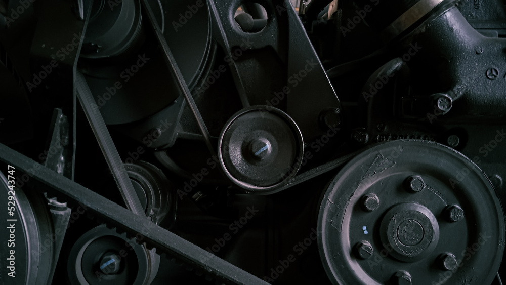 Timing belt with rollers installed on the old engine in a car workshop ...