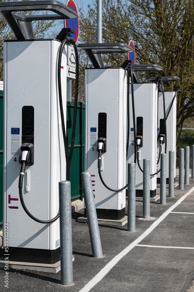 Close up of an electric vehicle charging station on a roadside car park ...