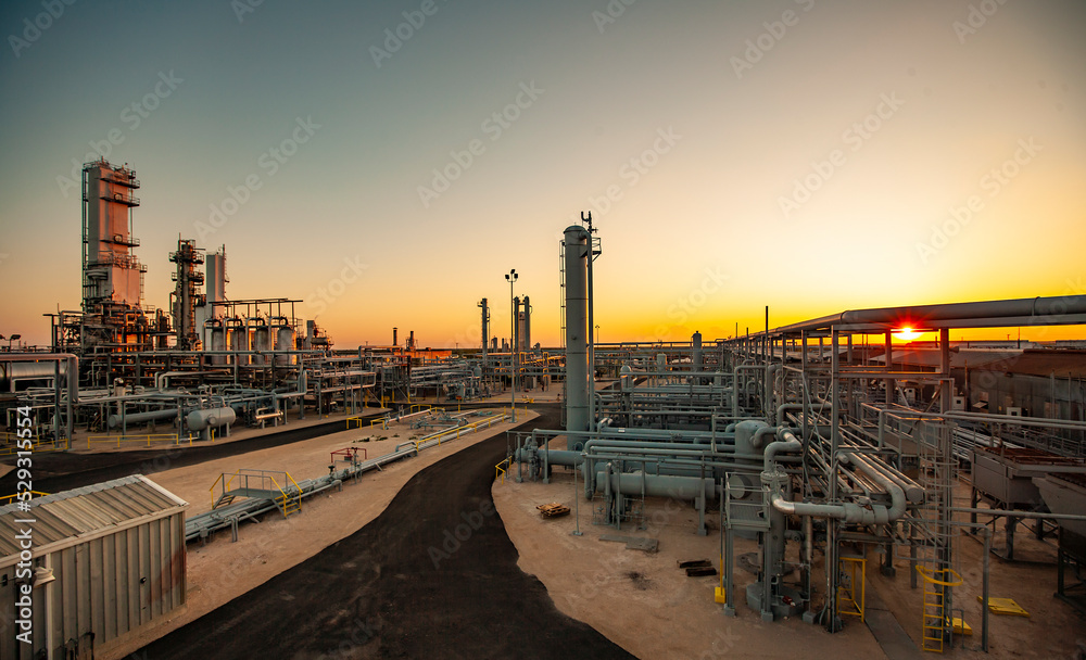Petrochemical plant at Permian Basin against clear sky during sunset ...