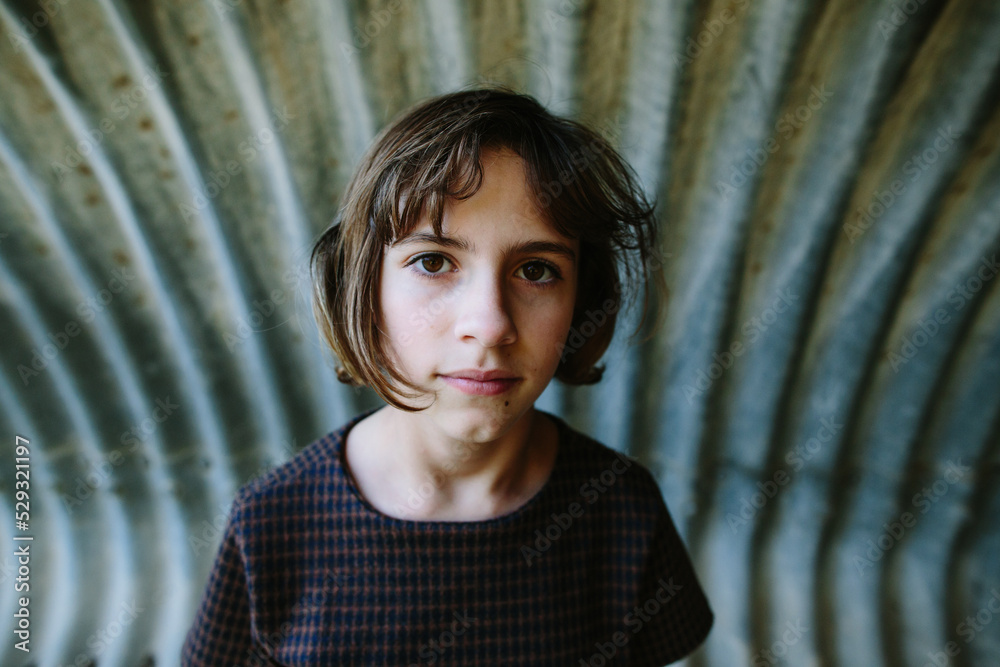 Tween girl with messy hair and a serious expression Stock Photo | Adobe ...